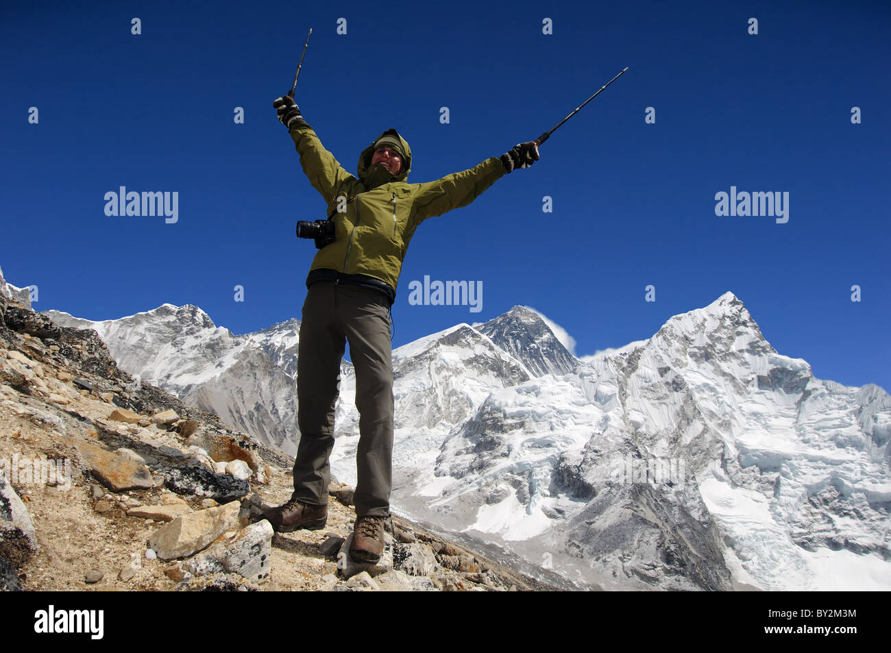 A lady trekker celebrates arriving at the summit of Kala Pattar in ...