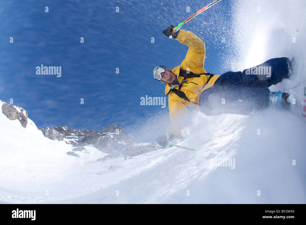 Man skiing powder with snow flying, shot from the skis perspective ...