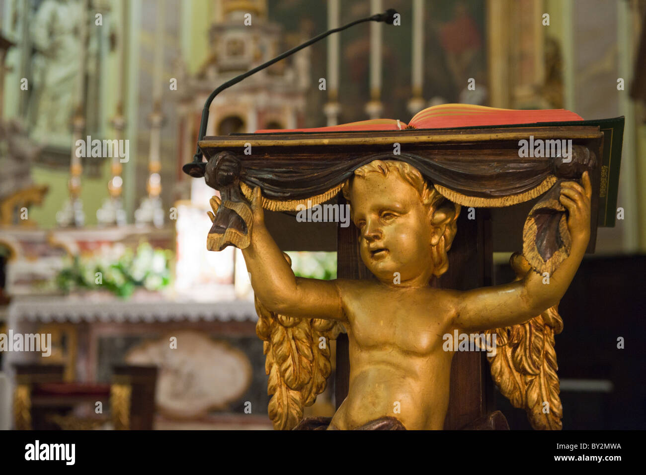 Golden pulpit with angel and bible in the Italian church Stock Photo ...