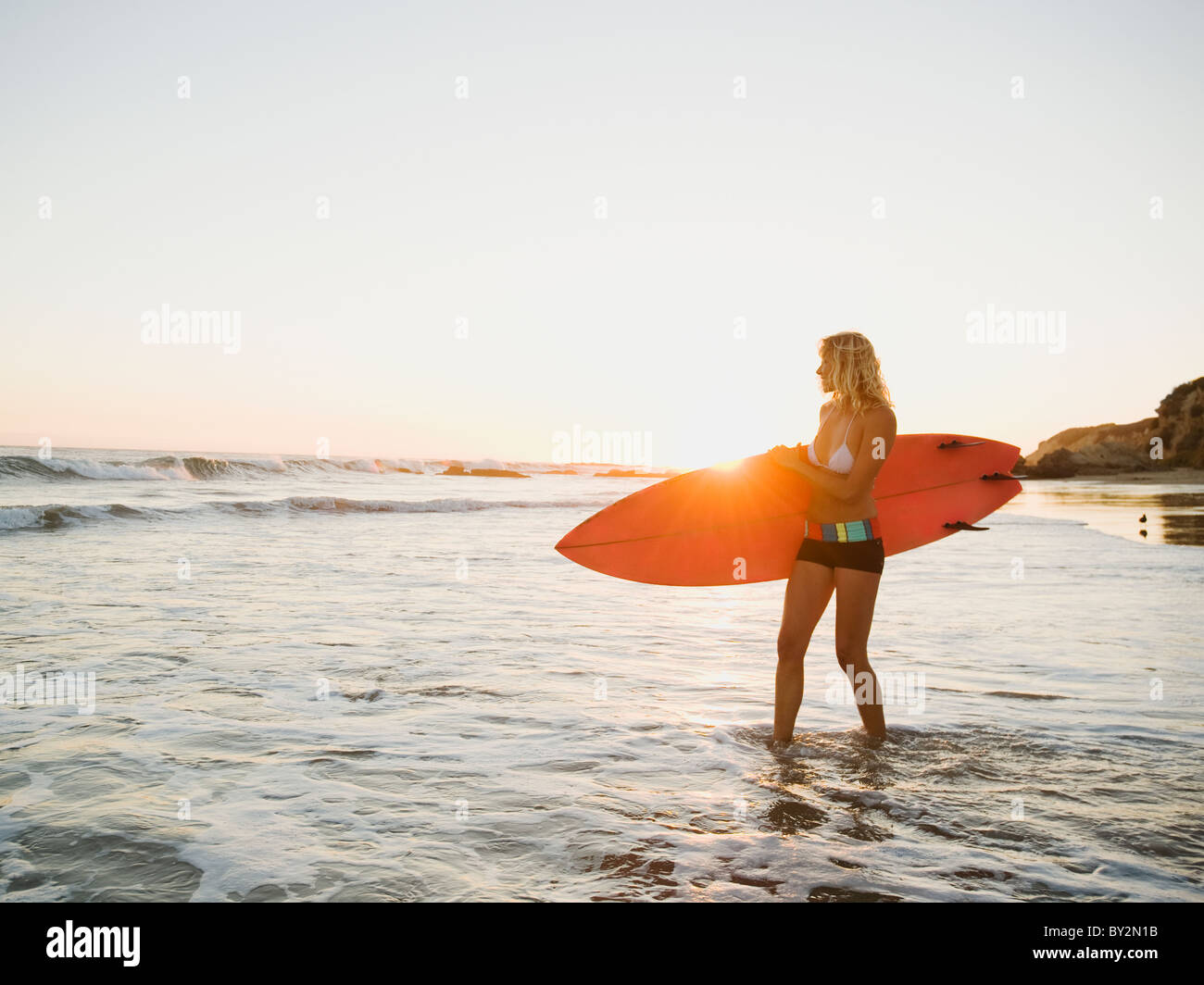 Portrait of woman with surfboard Stock Photo - Alamy
