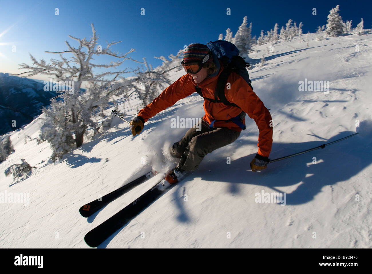 A male skier skis a 3000' face off Mt. Taylor during a beautiful winter ...