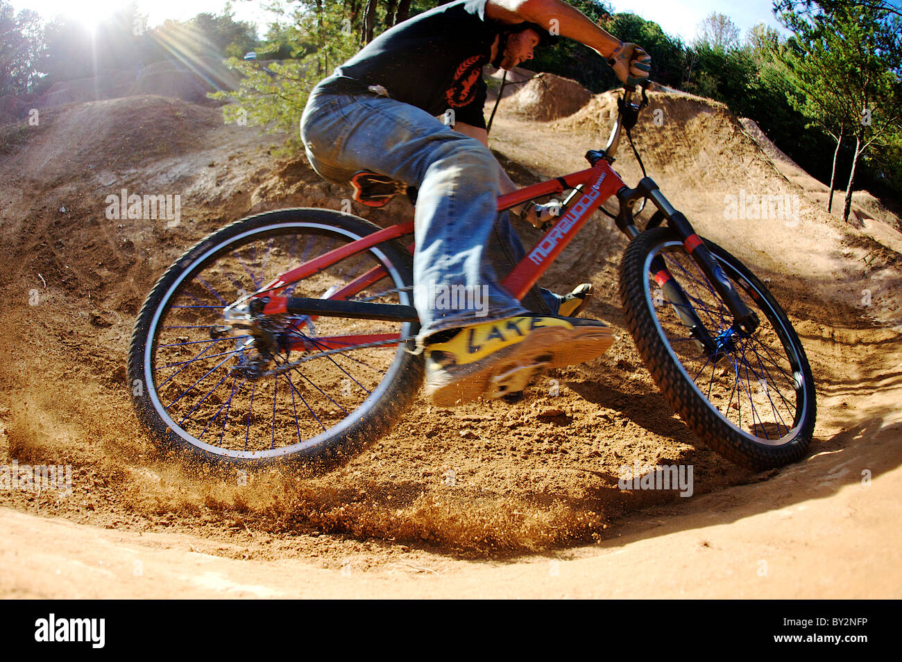 A man carving a berm on a mountain bike Stock Photo - Alamy