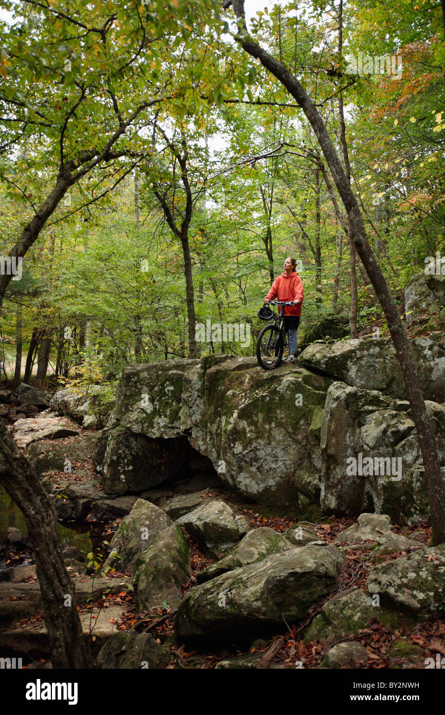 A woman rides a mountain bike on a trail in the woods near Chapel Hill ...