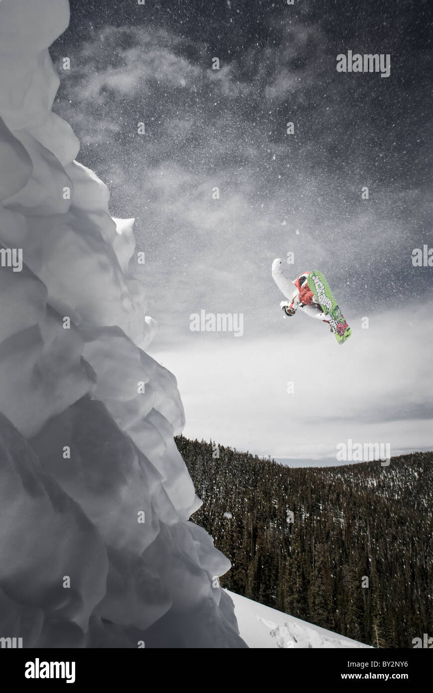 Side angle view of a snowboarder spinning off a jump in the Colorado ...