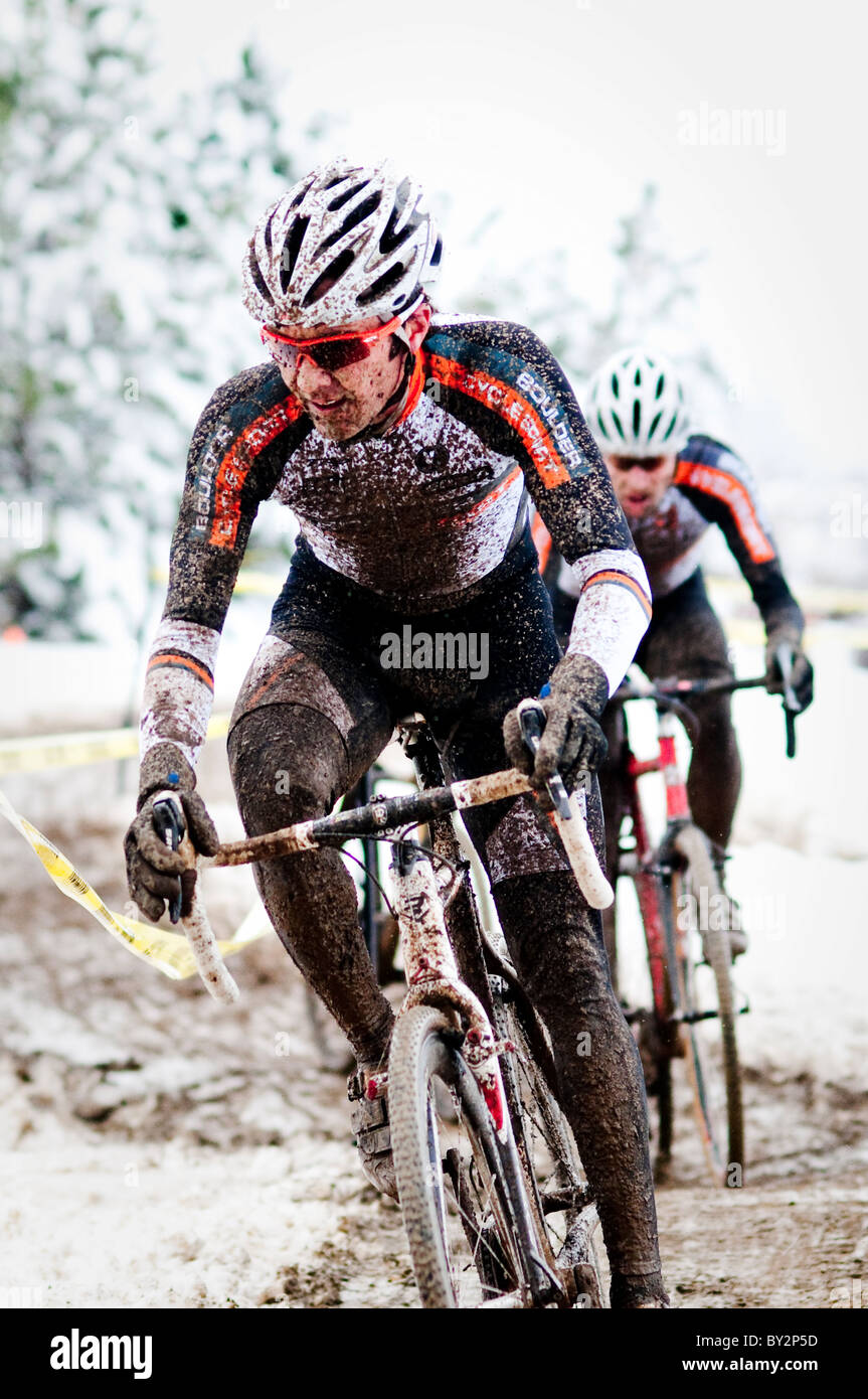 A cyclists races in the mud and snow at a Cyclocross race in Boulder ...