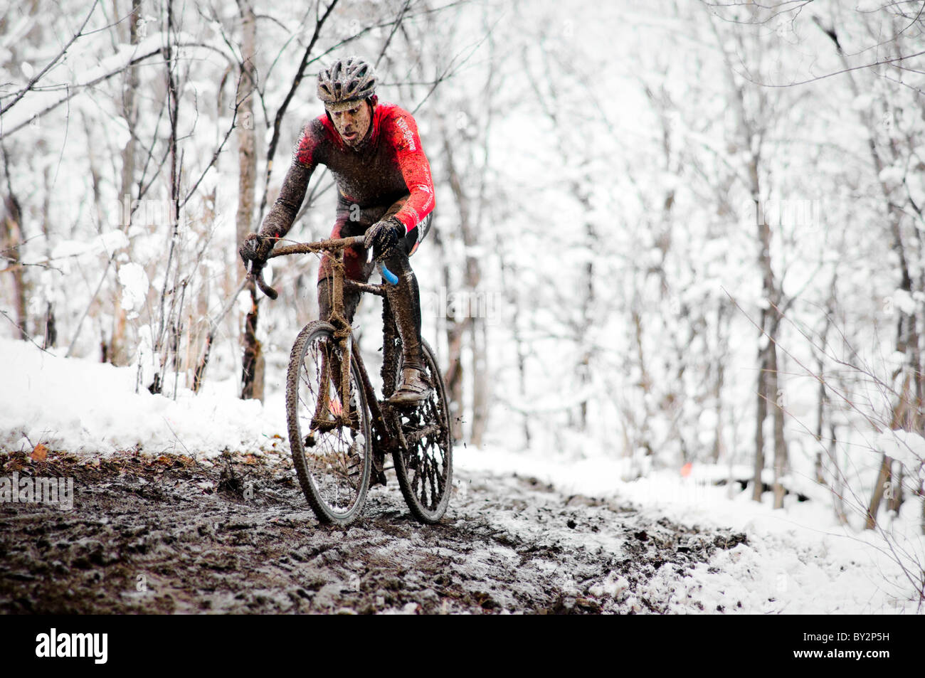 A cyclists races in the mud and snow at a Cyclocross race in Boulder ...