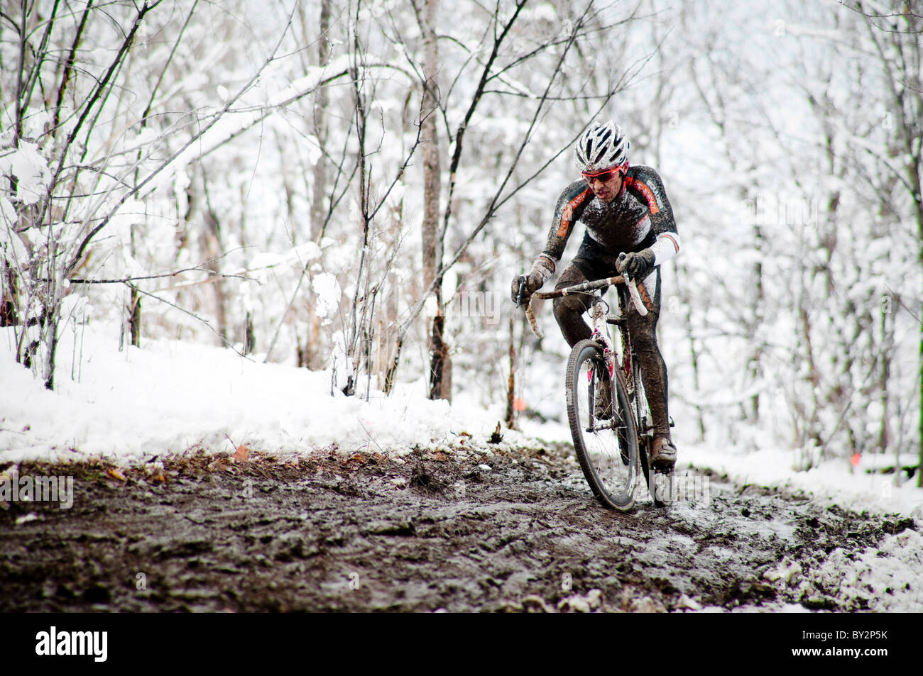 A cyclists races in the mud and snow at a Cyclocross race in Boulder ...