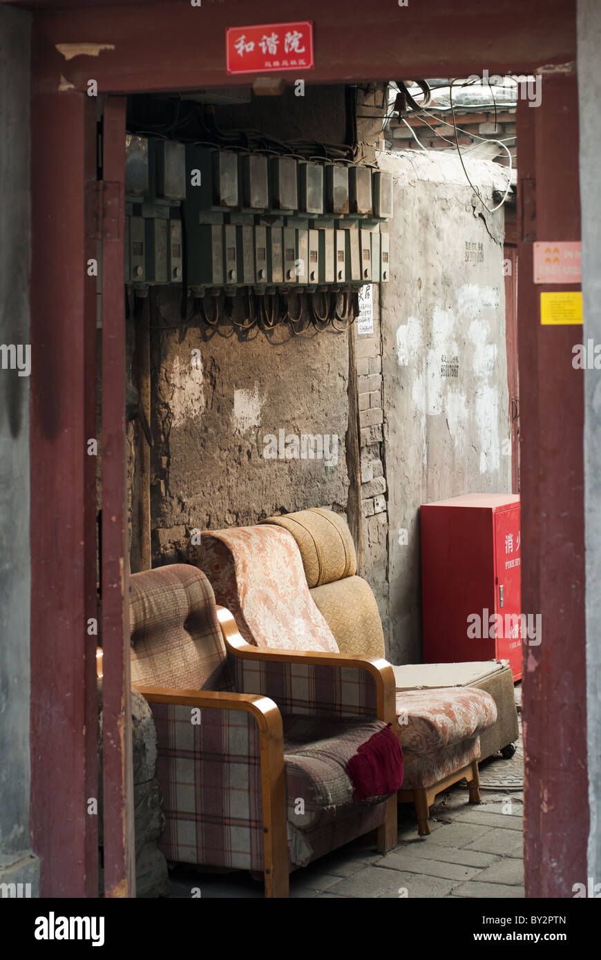 sofa chairs at the entrance of a residential yard in a Beijing's alley ...