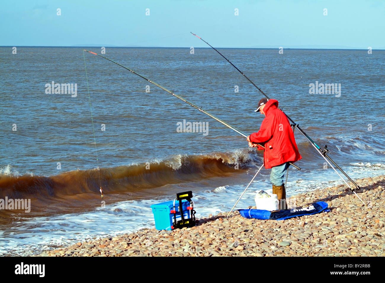 sea angler fishing from the beach Stock Photo - Alamy