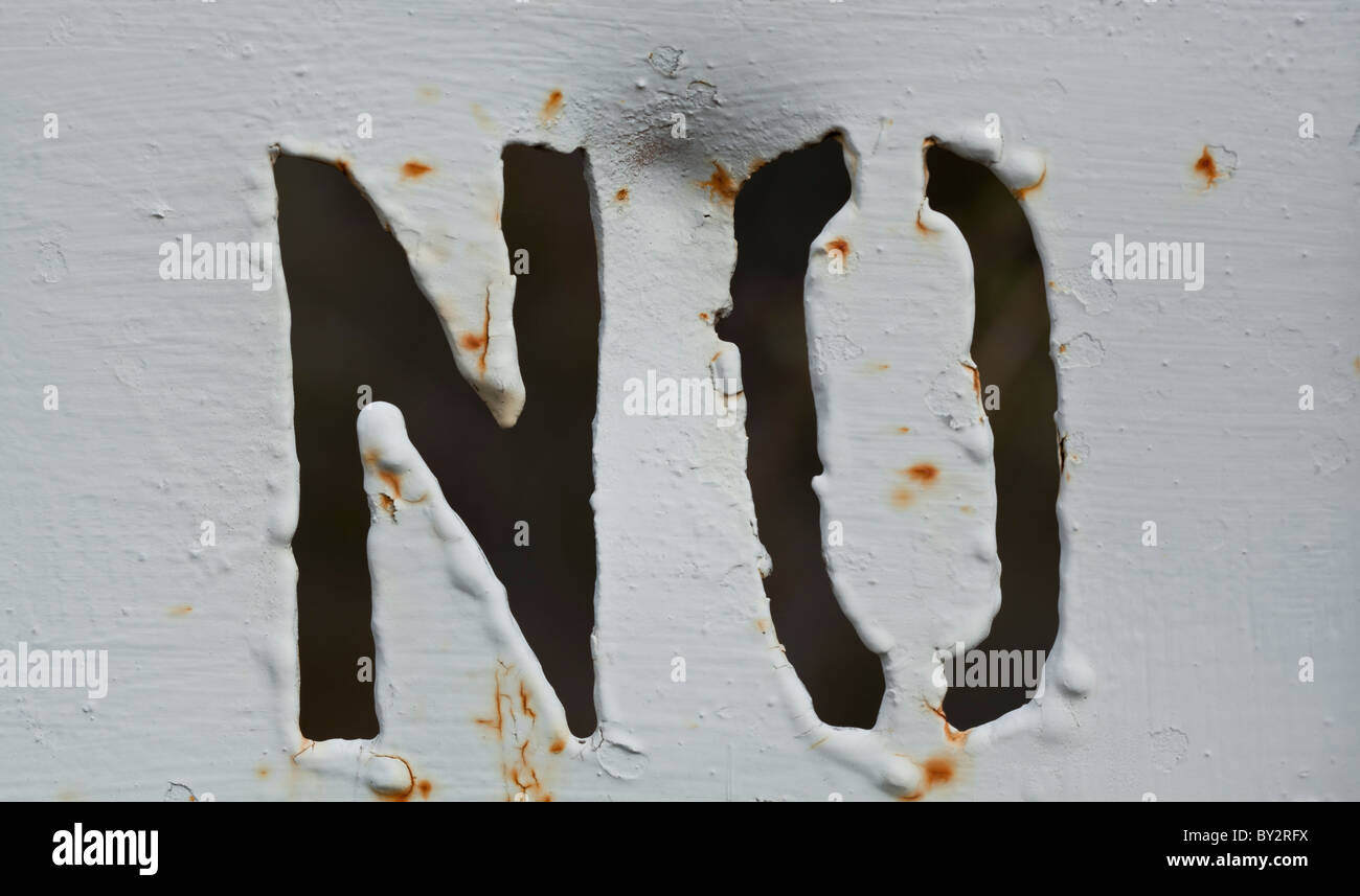 No cut out in an iron sign, painted white with some rust. The "NO" has ...