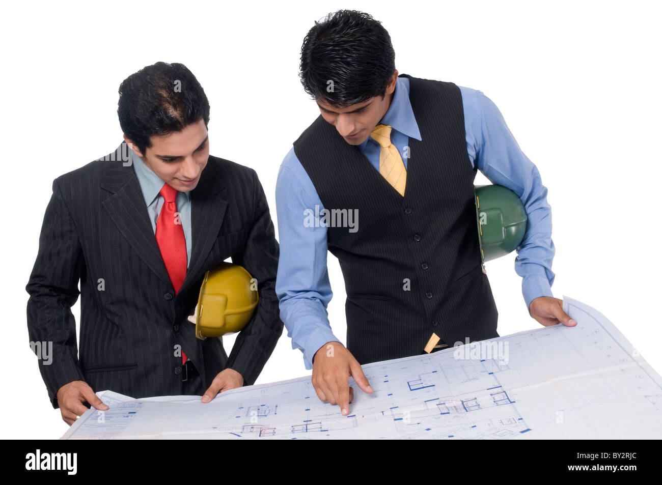 Two Indian professionals looking at a blueprint Stock Photo - Alamy