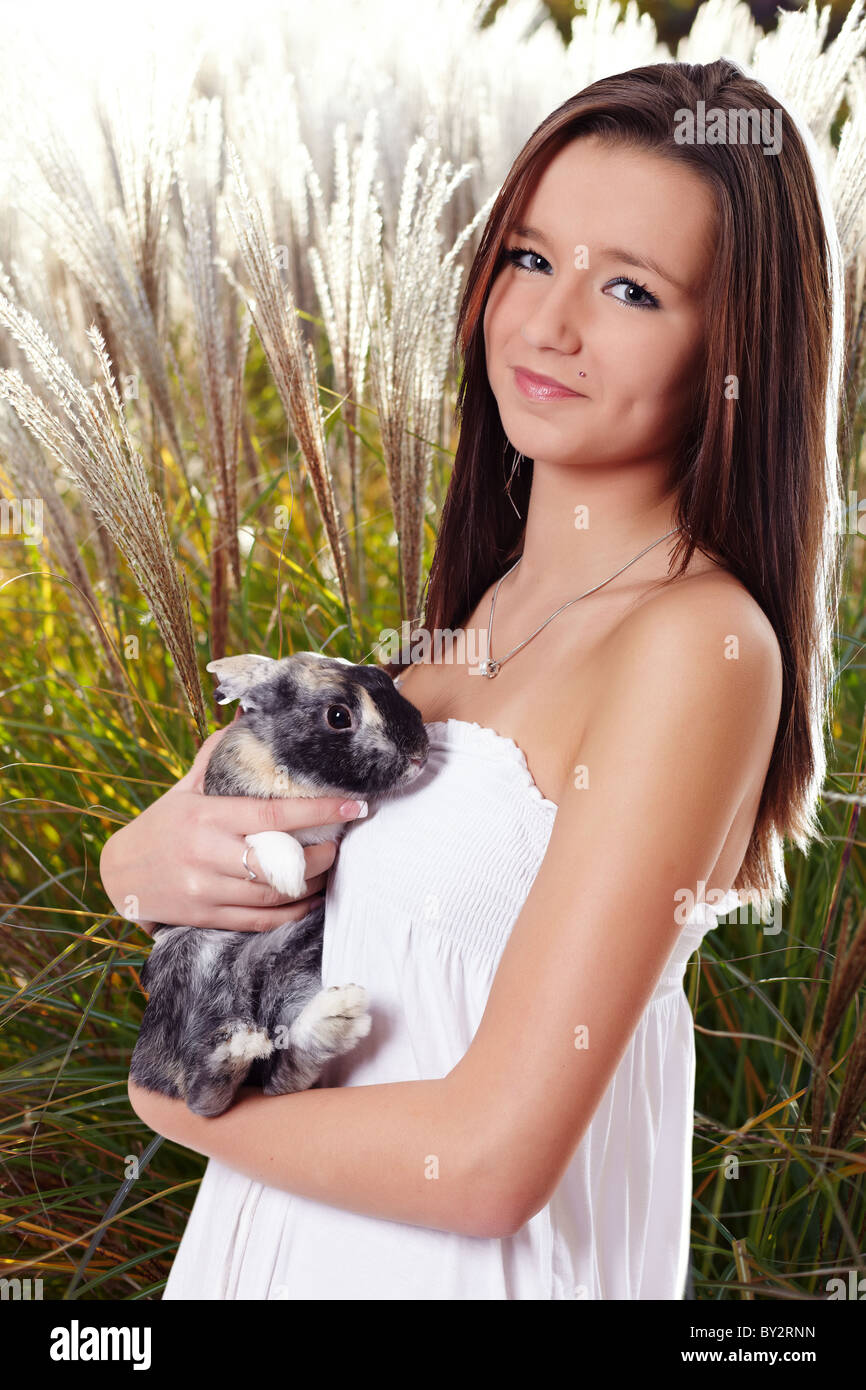 Young woman holding a rabbit Stock Photo - Alamy