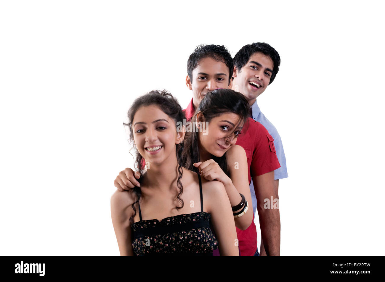 Four people standing in a line facing the camera Stock Photo - Alamy