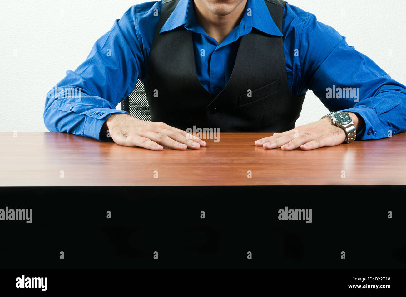 A professionally dressed man sitting at a desk Stock Photo - Alamy