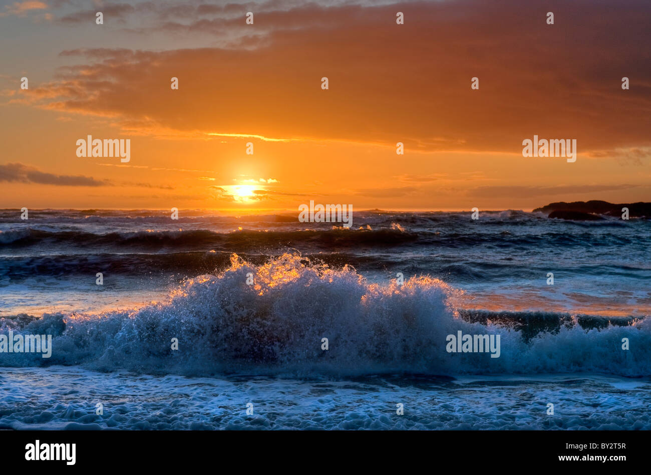 sunsetting over breaking waves Stock Photo - Alamy