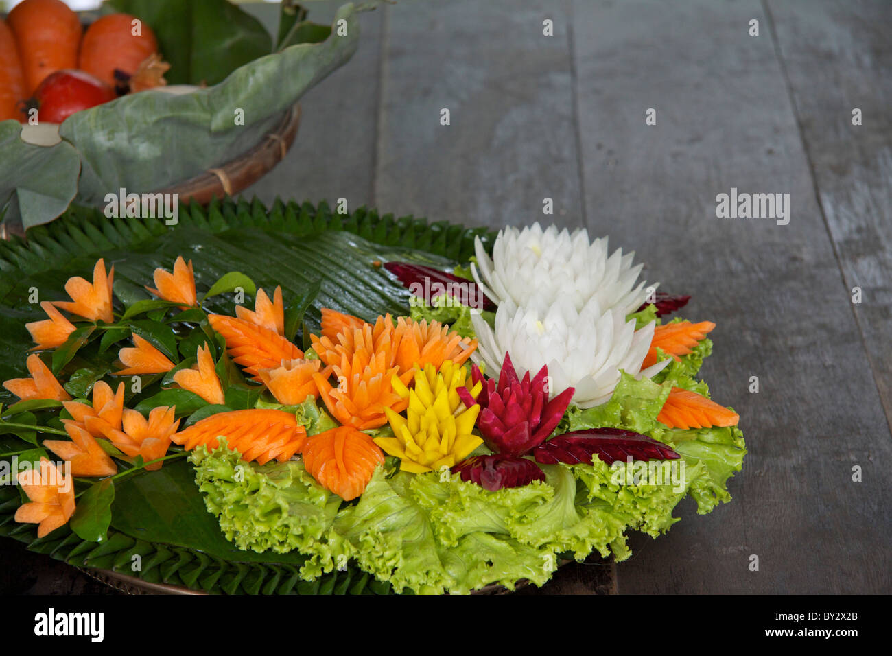 Intricately carved vegetables in the shape of flowers and leaves ...