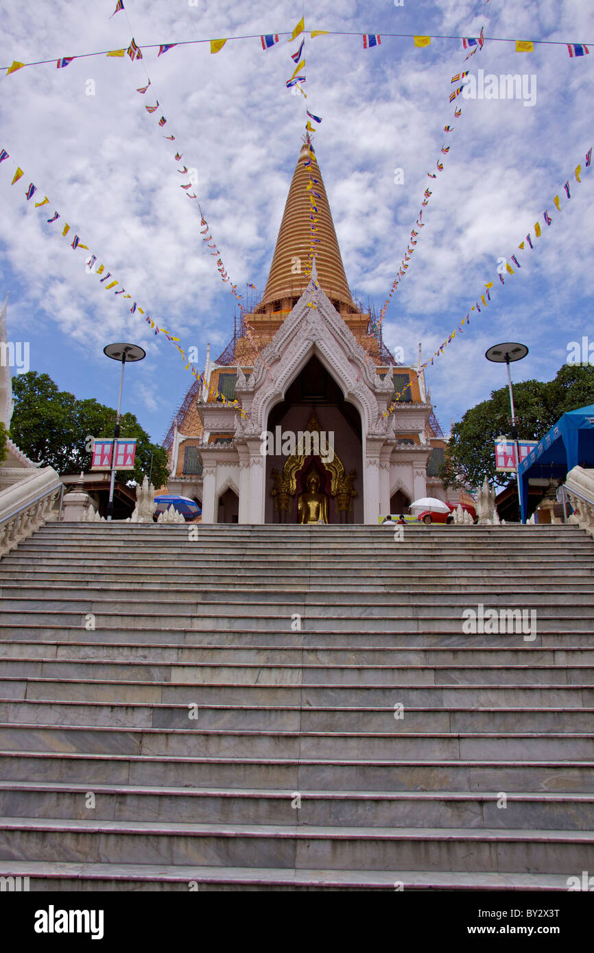 Steps leading up to the entrance of Phra Pathom Chedi with flags and ...