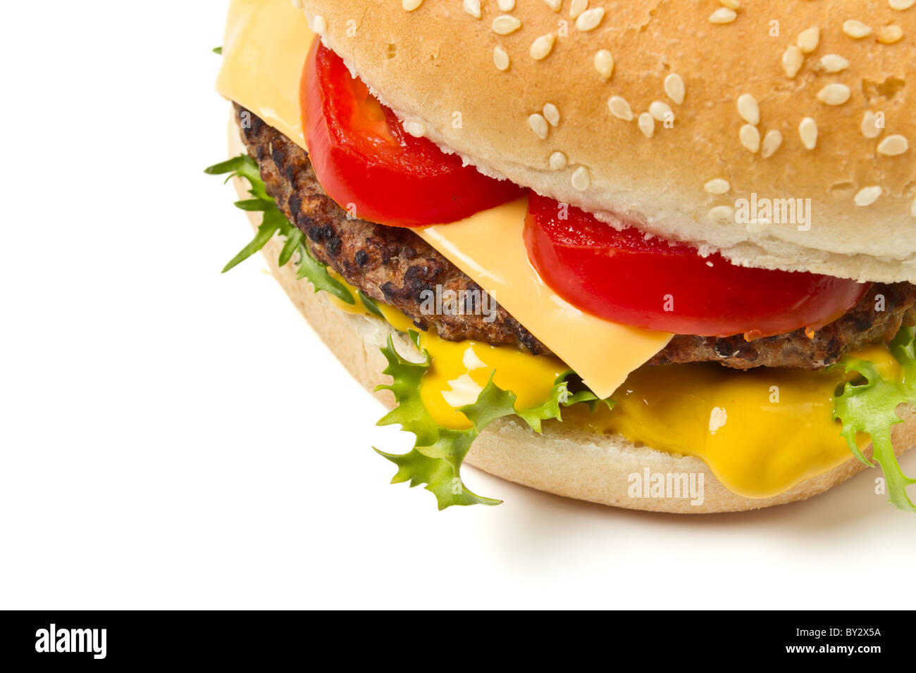 Cheeseburger and Mustard in sesame seeded bun isolated on white Stock ...