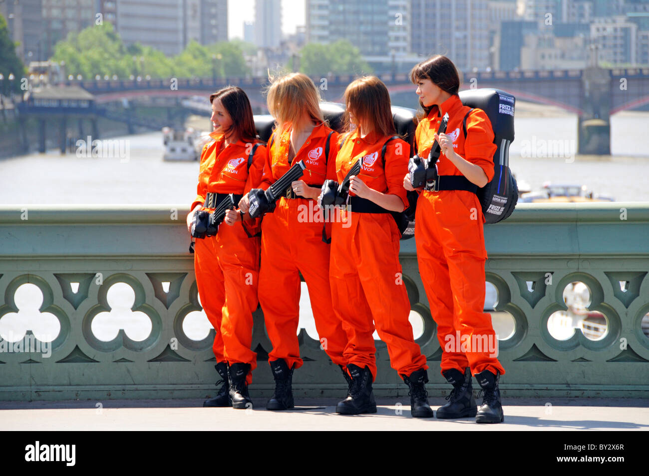 Four models posing for publicity shots to promote Avon frizz products ...