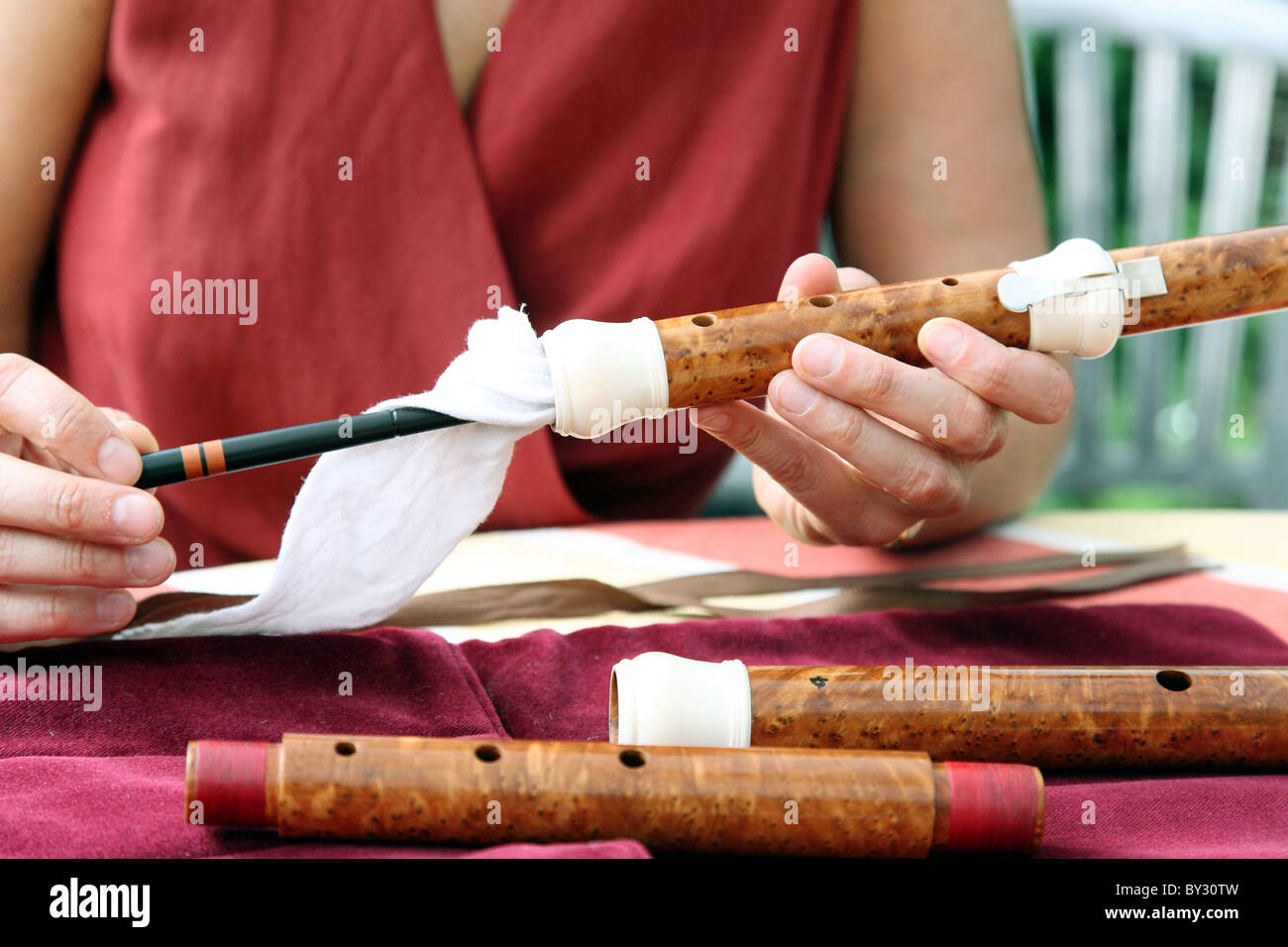 A woman cleaning a transverse flute Stock Photo - Alamy
