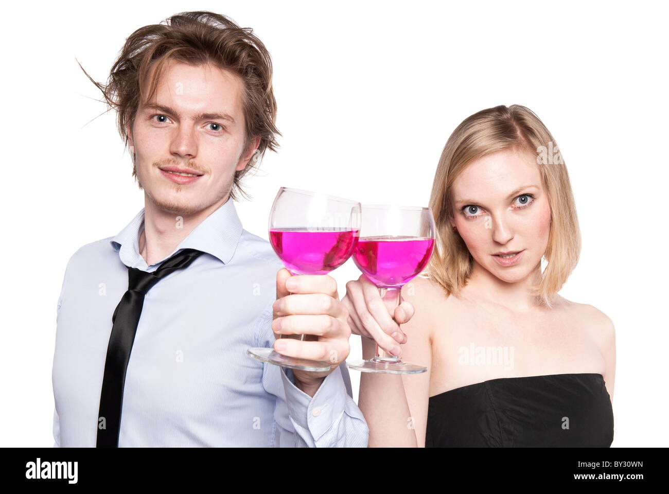 Young couple toasting with pink drink. Two people drinking. Studio ...