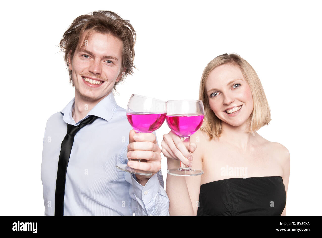 Young couple toasting with pink drink. Two people drinking. Studio ...