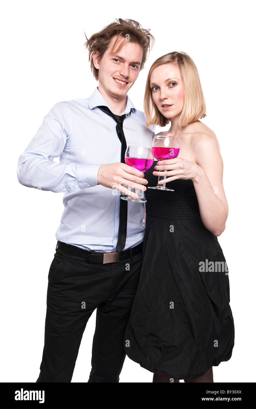 Young couple toasting with pink drink. Two people drinking. Studio ...