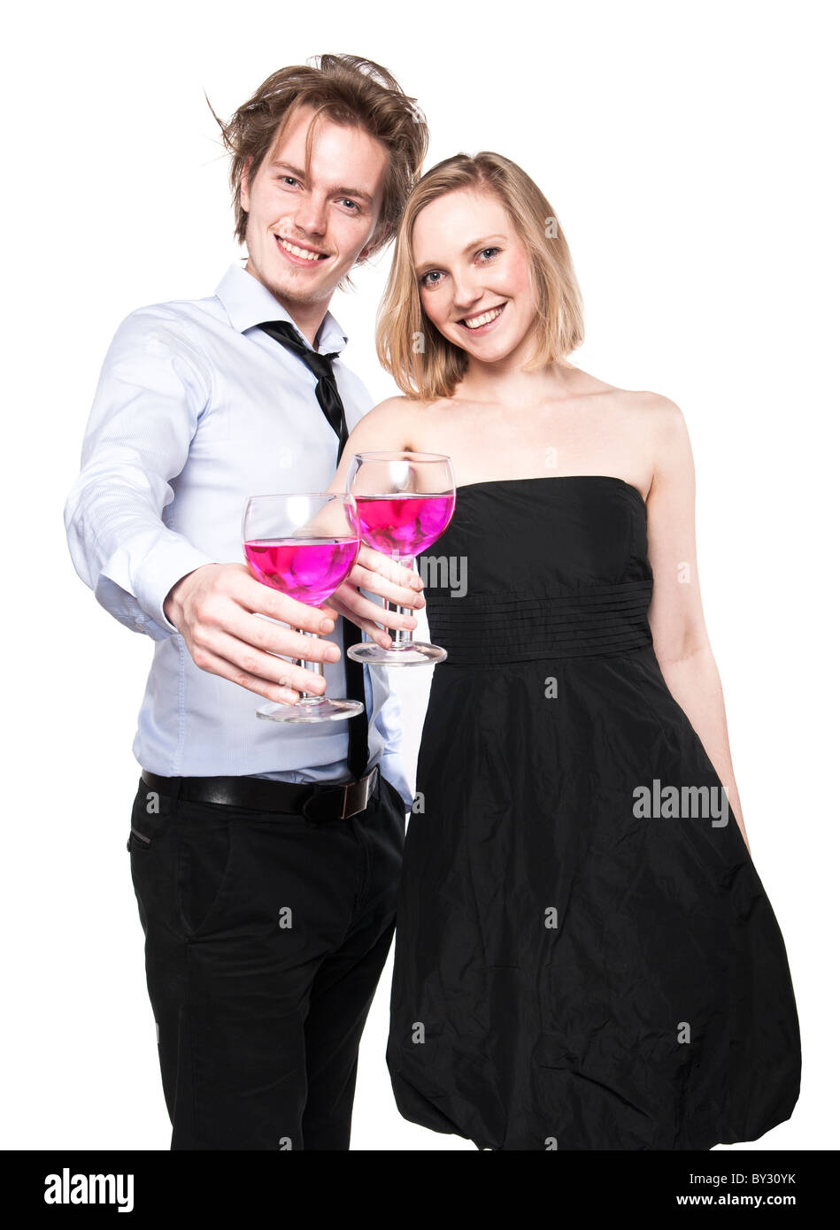 Young couple toasting with pink drink. Two people drinking. Studio ...