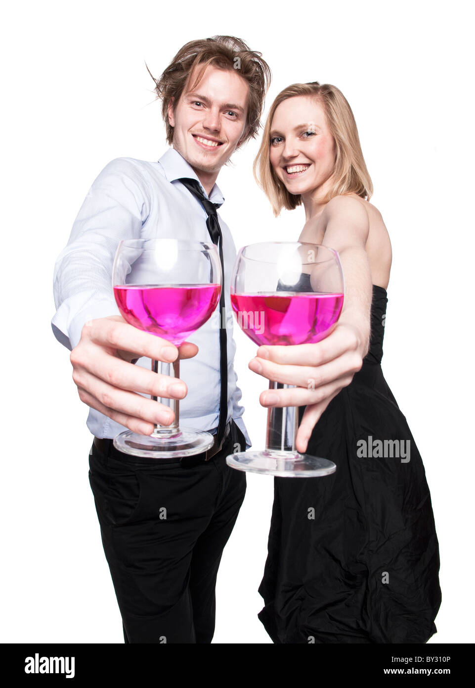 Young couple toasting with pink drink. Two people drinking. Studio ...