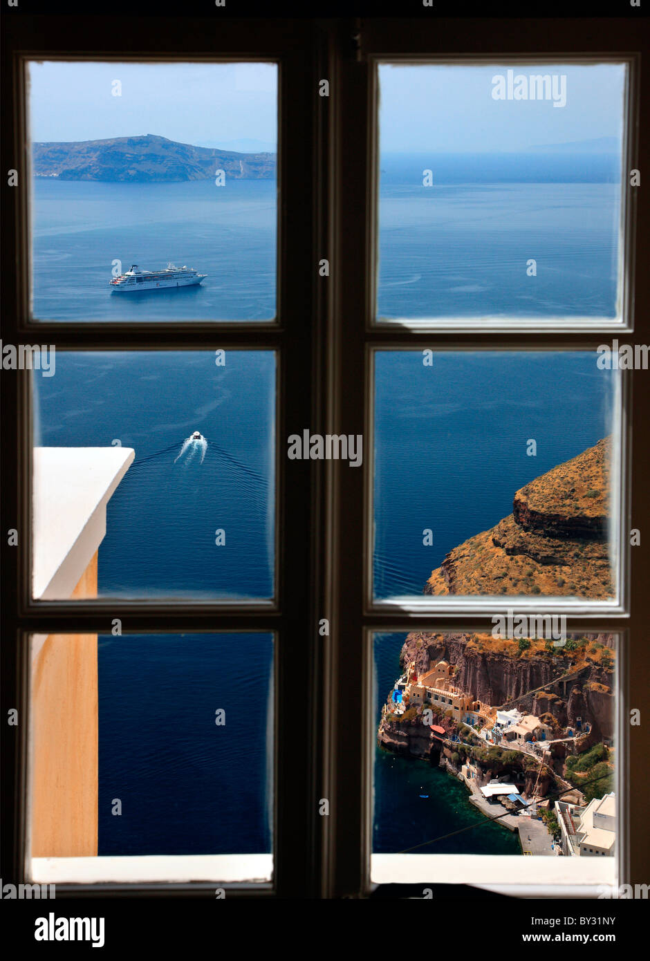 A view of the caldera through a window in Fira village, Santorini ...