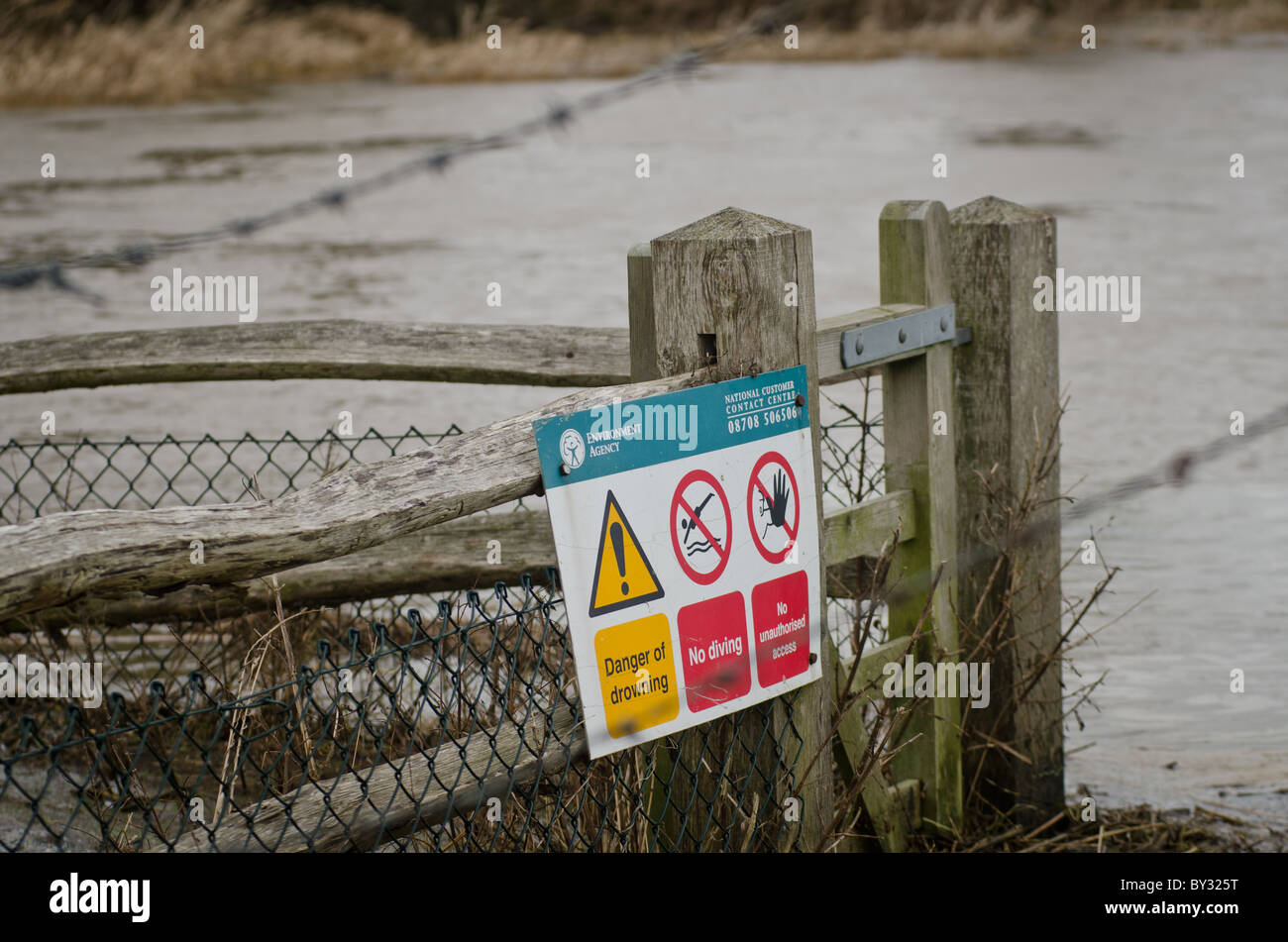 Water logged field with warning sign of flooding Stock Photo - Alamy