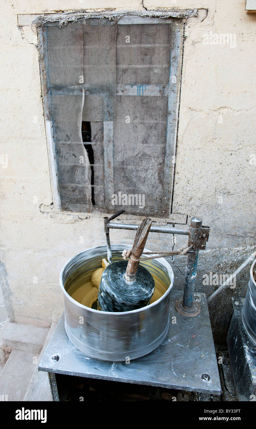 Motorized grinder by an indian house grinding dal and jaggery for ...