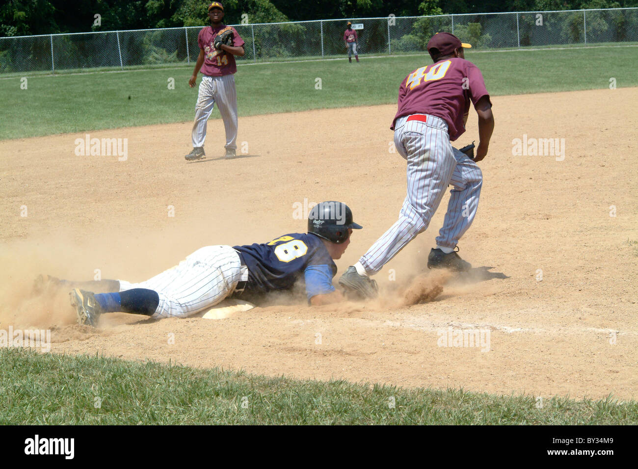 Player slides and is safe on base in a high school baseball game Stock ...