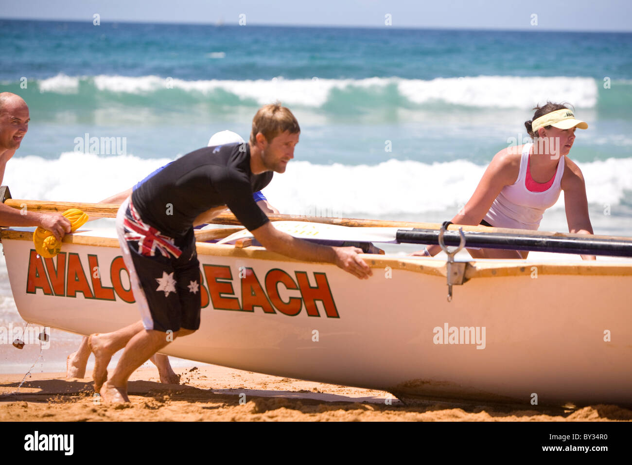 men and women pushing a timber surf rescue boat avalon,sydney,Australia ...