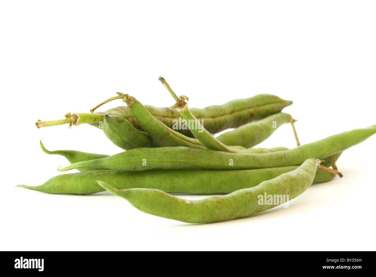 Detail view of green beans in pods on white background Stock Photo - Alamy