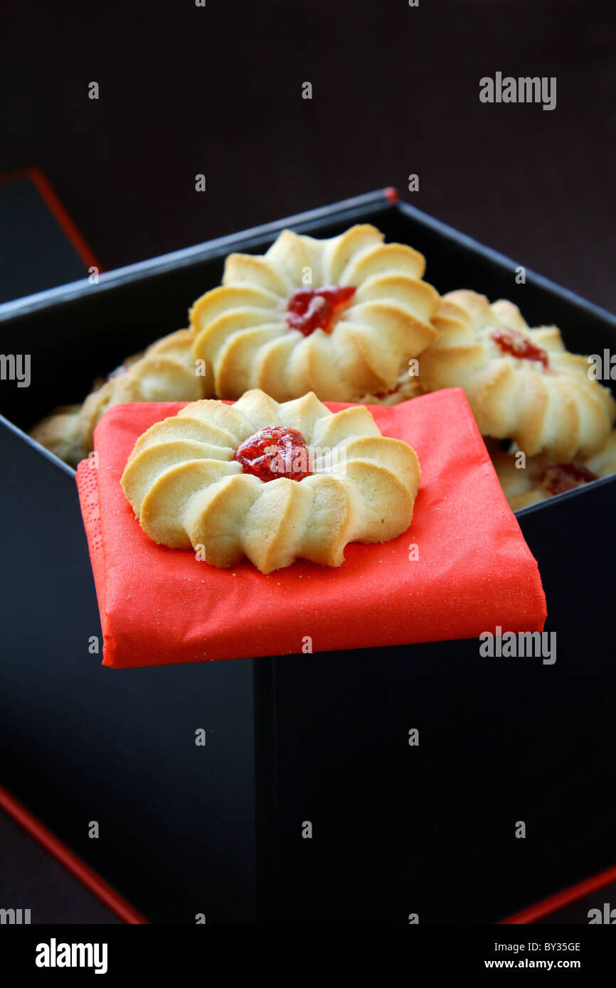 Beautiful cookies with jam on a brown background Stock Photo - Alamy