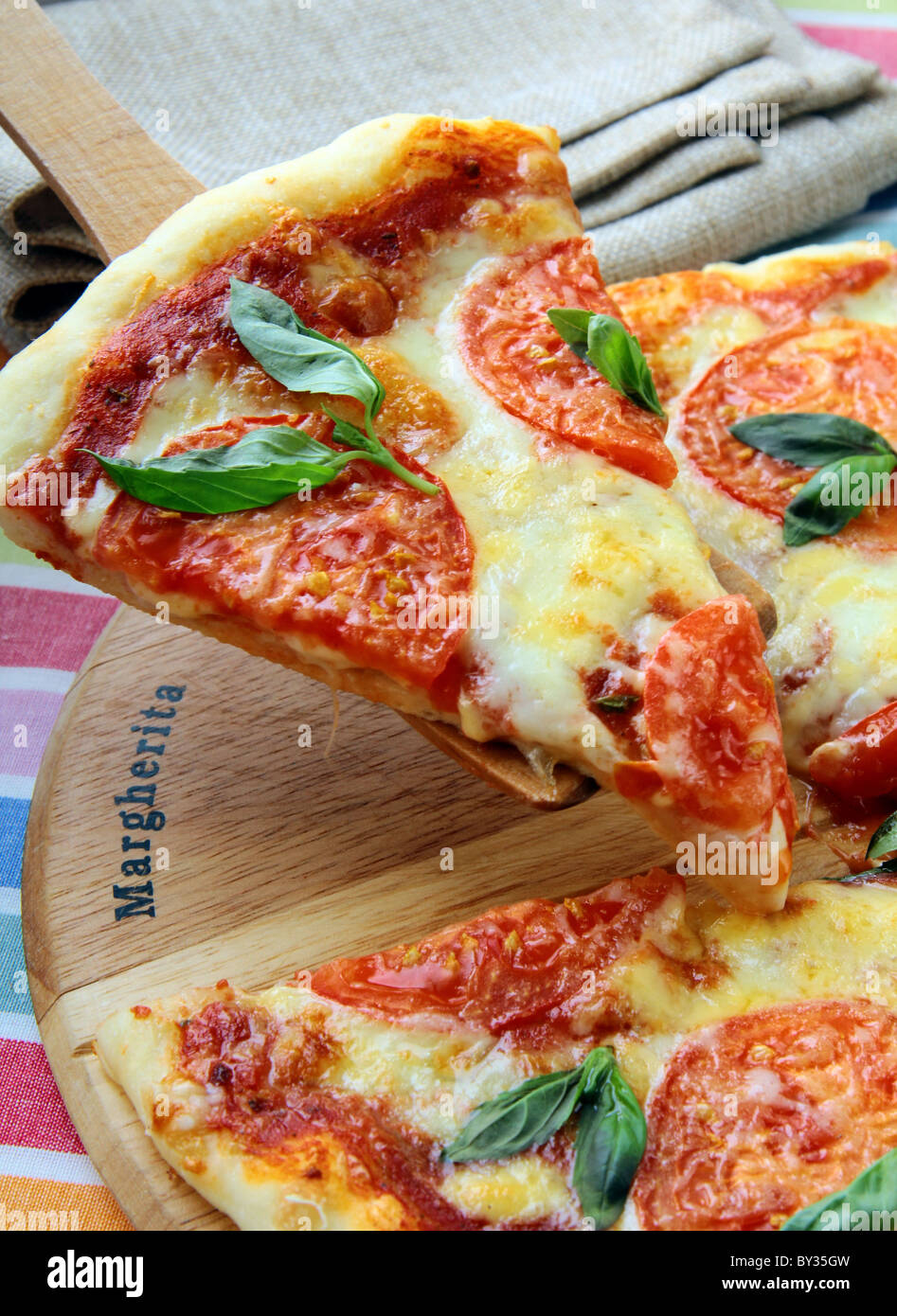 Margaritta pizza with tomatoes and basil cheese on the board Stock ...