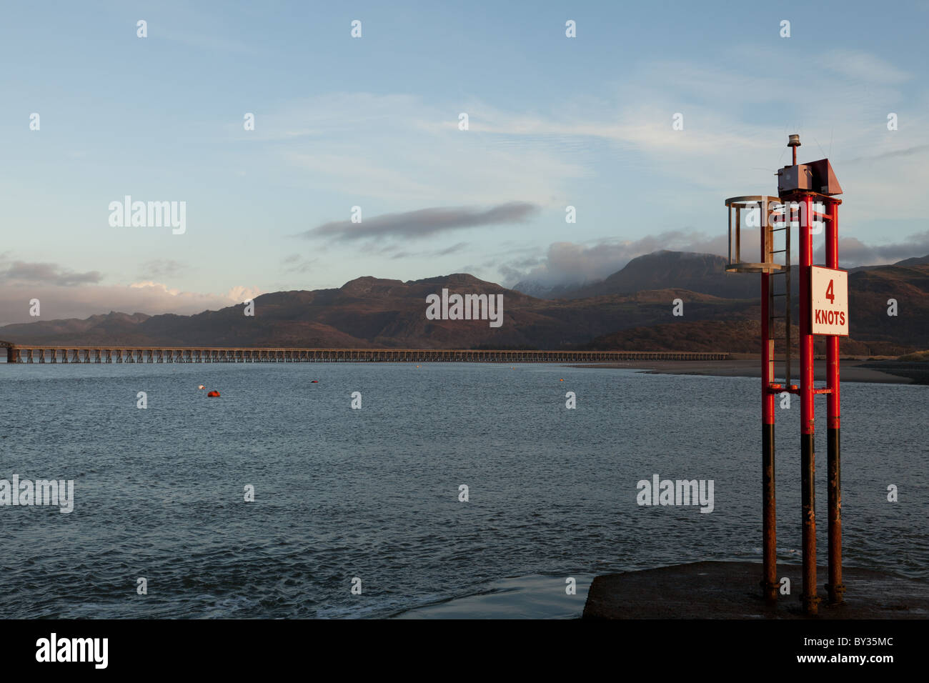 A speed restriction sign for boats on Barmouth pier. The railway ...