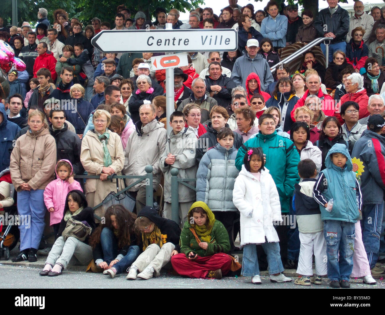 A large mixed crowd gather to watch a local celebration Stock Photo - Alamy