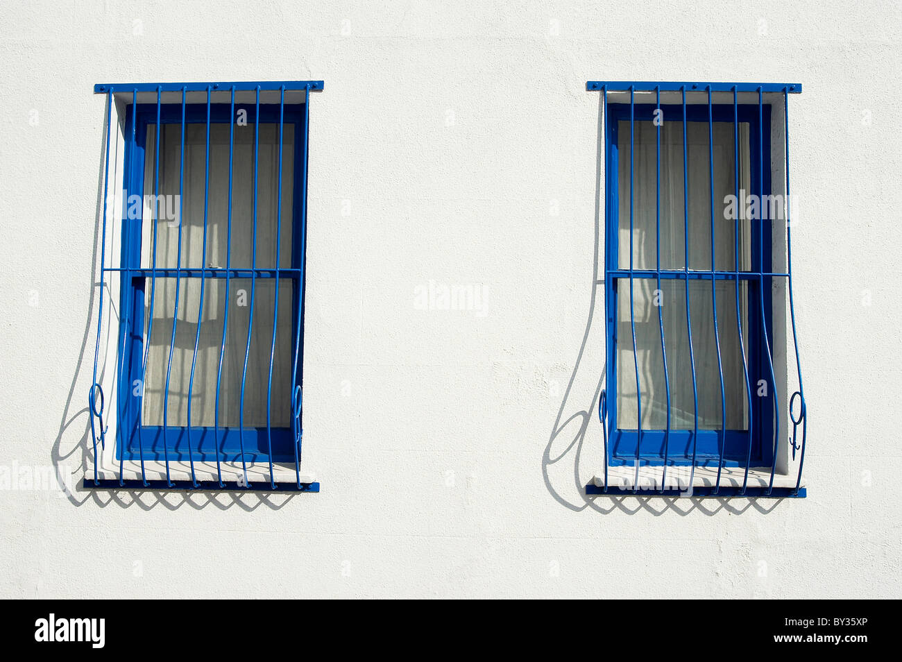 Two windows barred up for security Stock Photo - Alamy