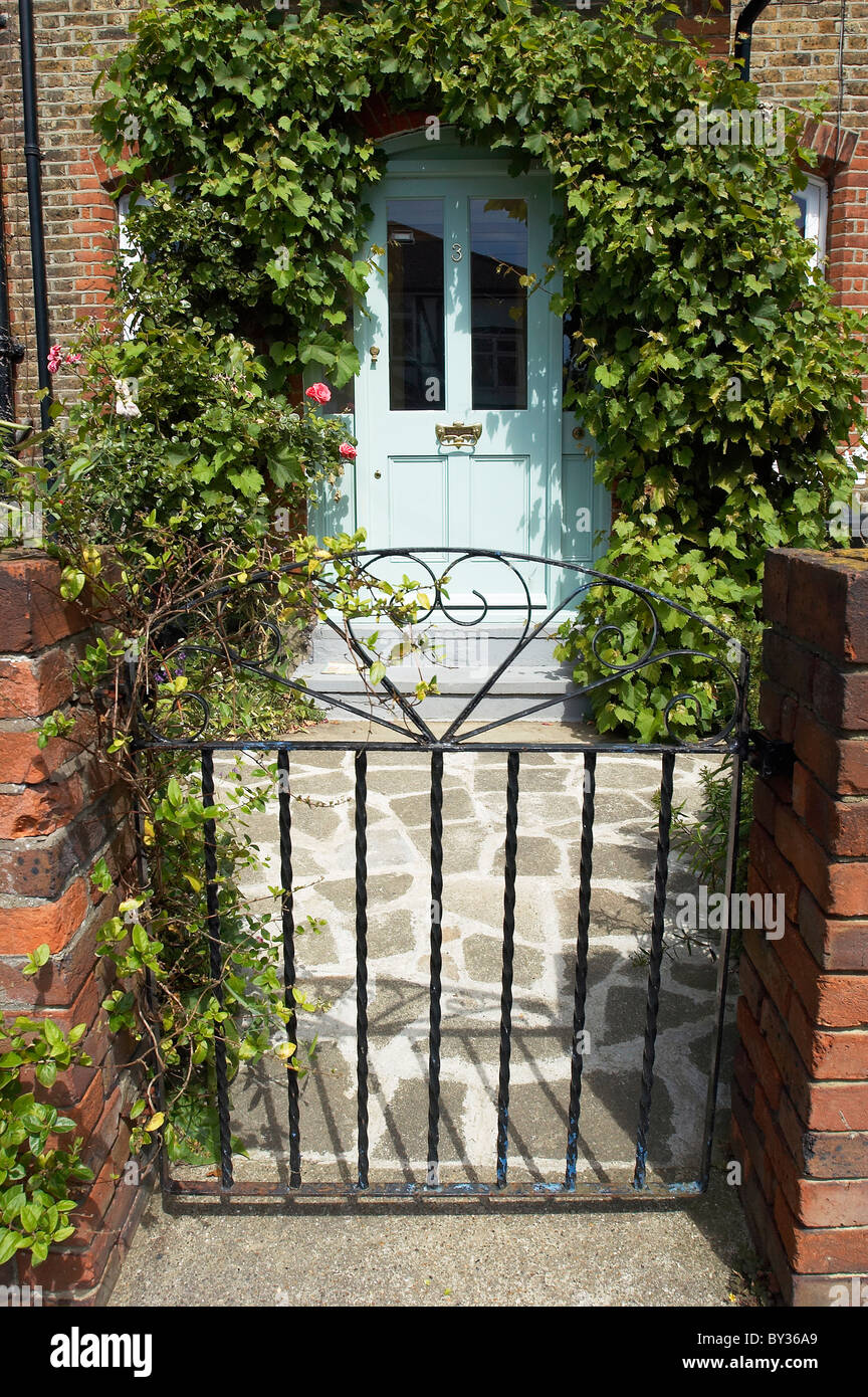 Front gate of a period property with crazy paving Stock Photo - Alamy
