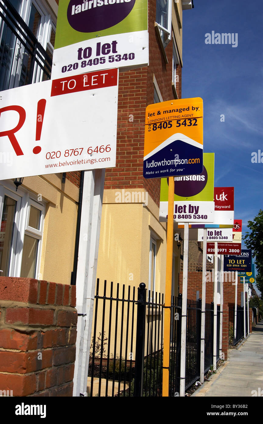 Estate Agent boards in front of houses London Stock Photo - Alamy