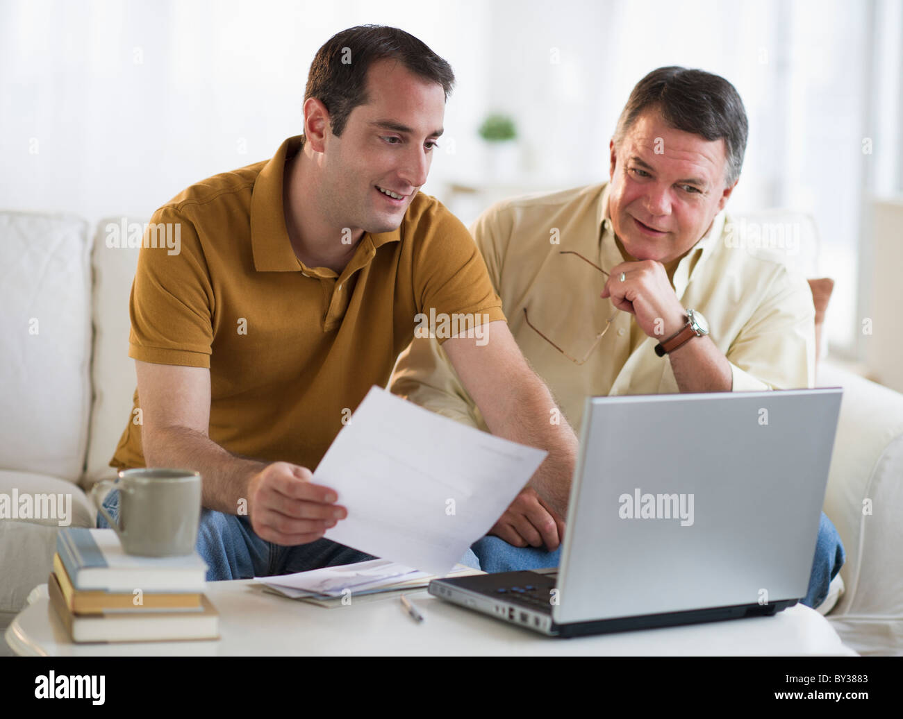 Father son using laptop together hi-res stock photography and images ...