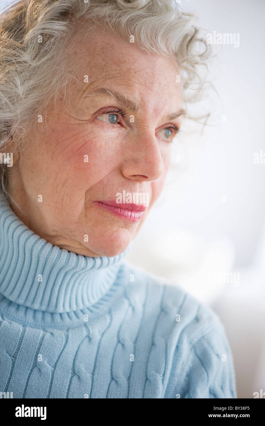 Pensive senior woman smiling Stock Photo - Alamy