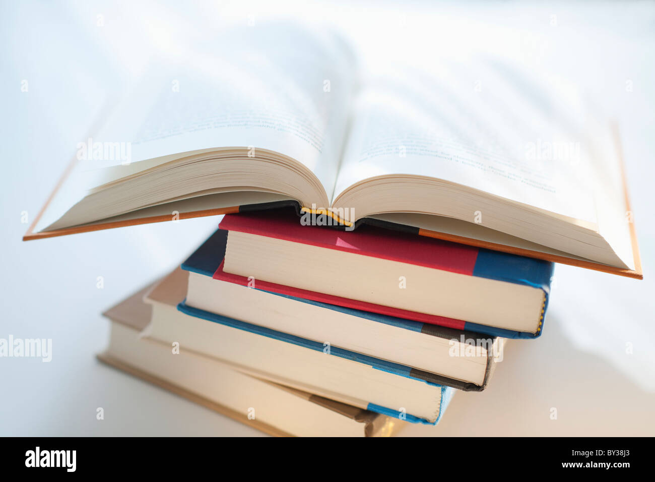Open book on stack Stock Photo - Alamy