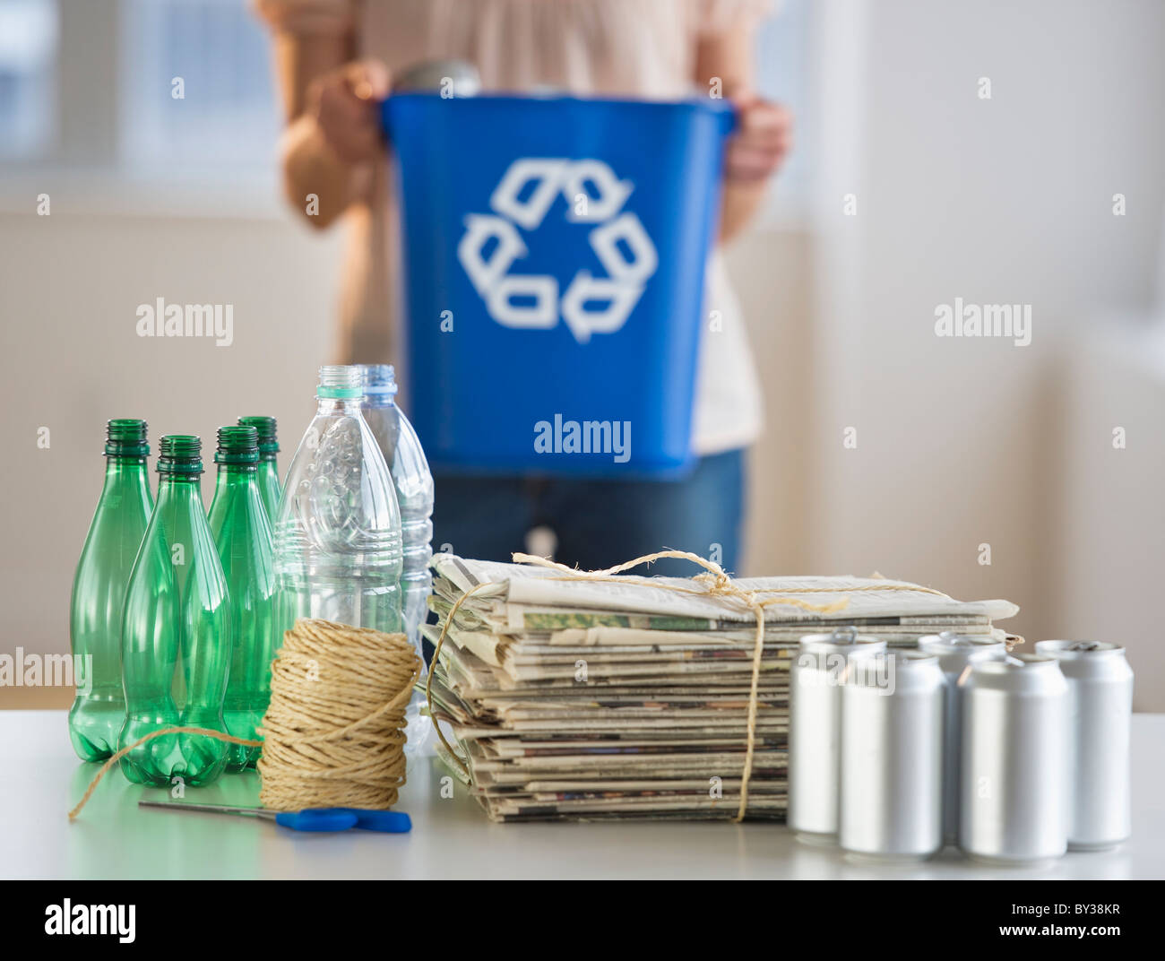 Woman recycling plastic bottles, cans and newspapers Stock Photo - Alamy