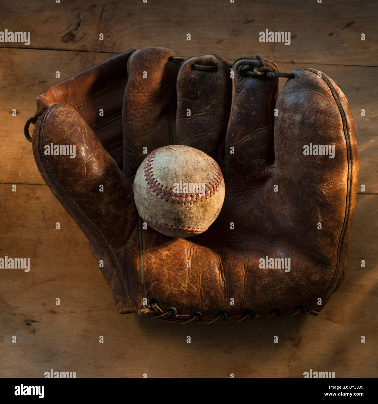 Antique baseball on baseball glove with bat Stock Photo - Alamy