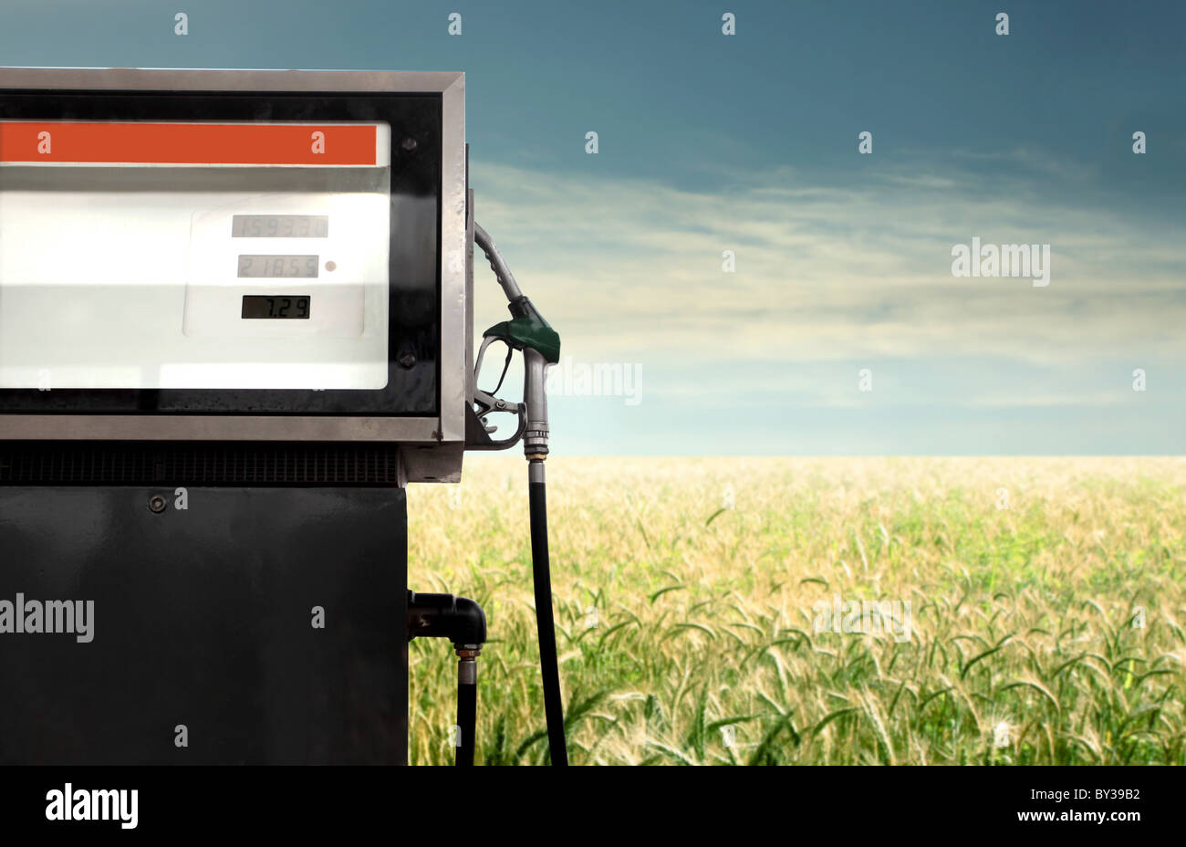 Fuel pump in the middle of a green field Stock Photo - Alamy