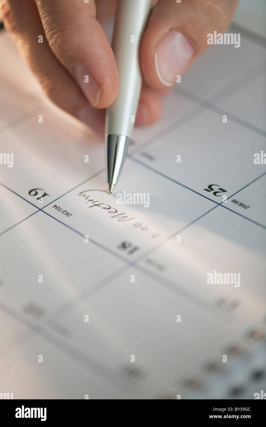 USA, New Jersey, Jersey City, Man writing on calendar Stock Photo - Alamy