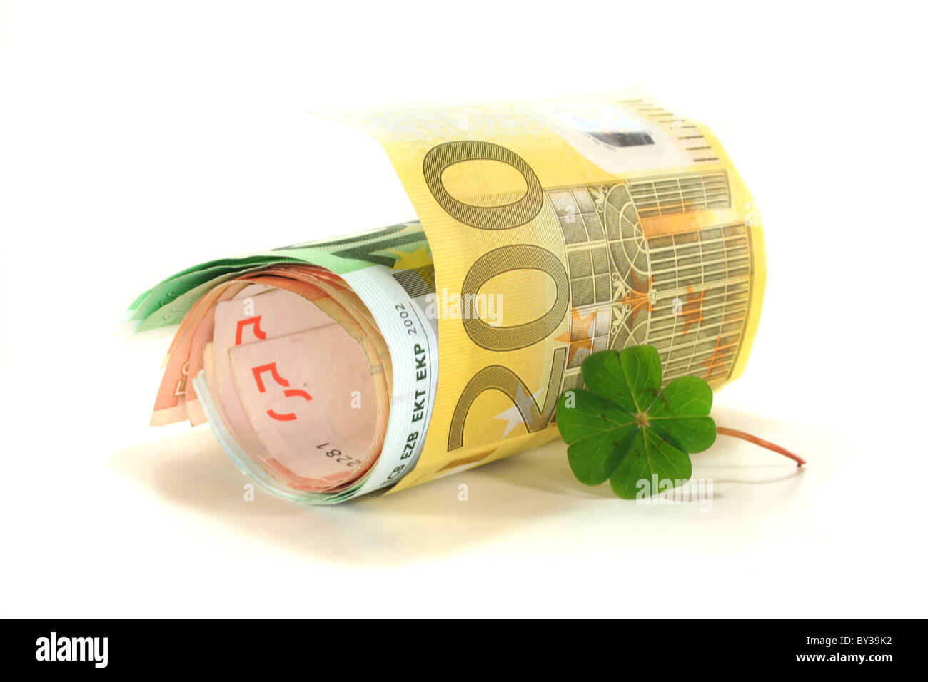Euro notes with four-leaf clover on white background Stock Photo - Alamy